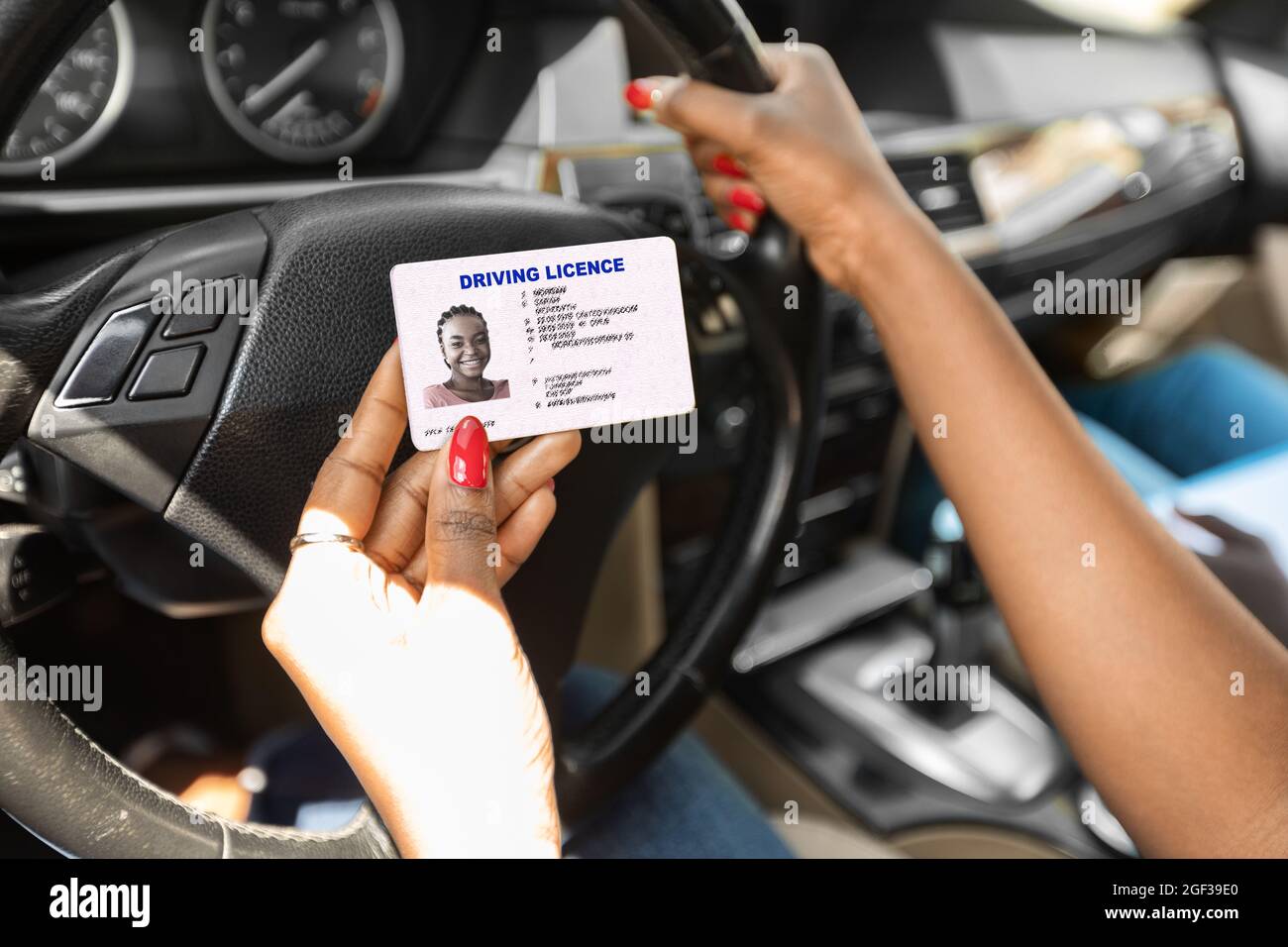 Newest driving license in black lady hands, closeup Stock Photo - Alamy