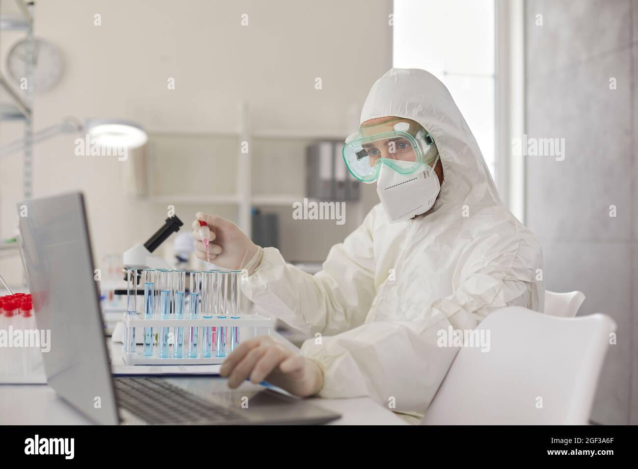 Scientist in laboratory conducts serious chemical research working with ...