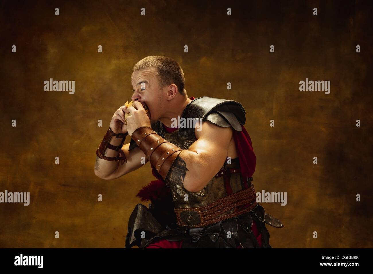 Portrait of young man, medieval warrior or knight in war equipment ...