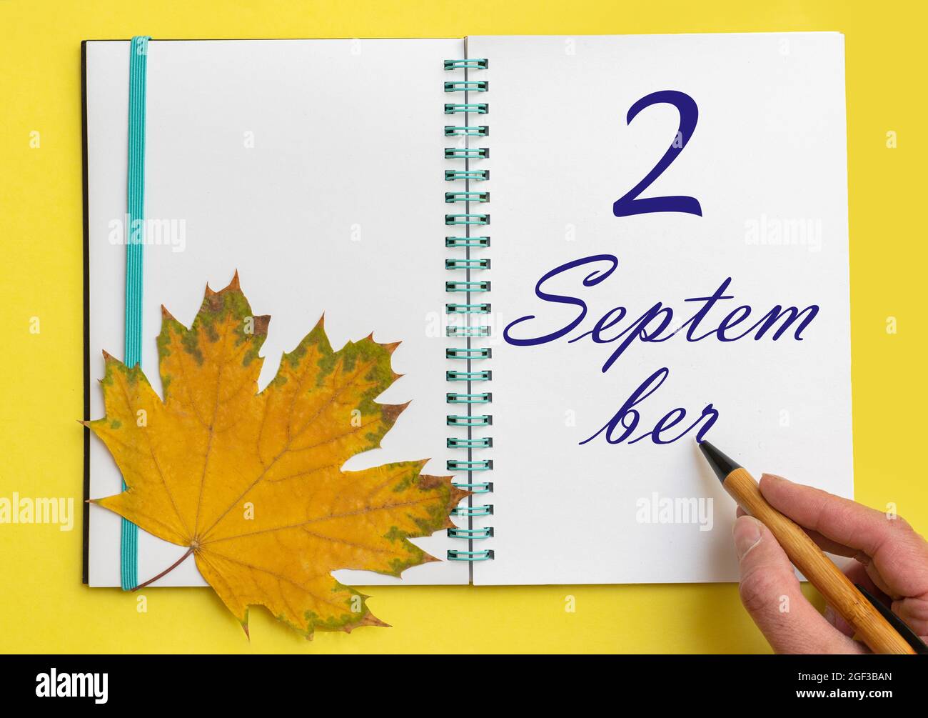 2nd day of september. Hand writing the date 2 september in an open ...