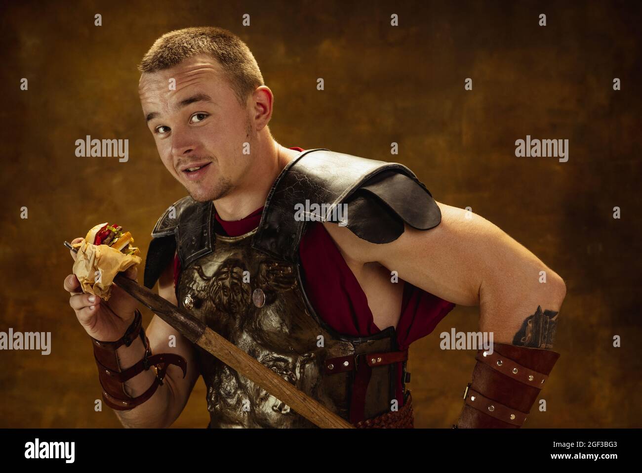 Portrait of young man, medieval warrior or knight in war equipment ...