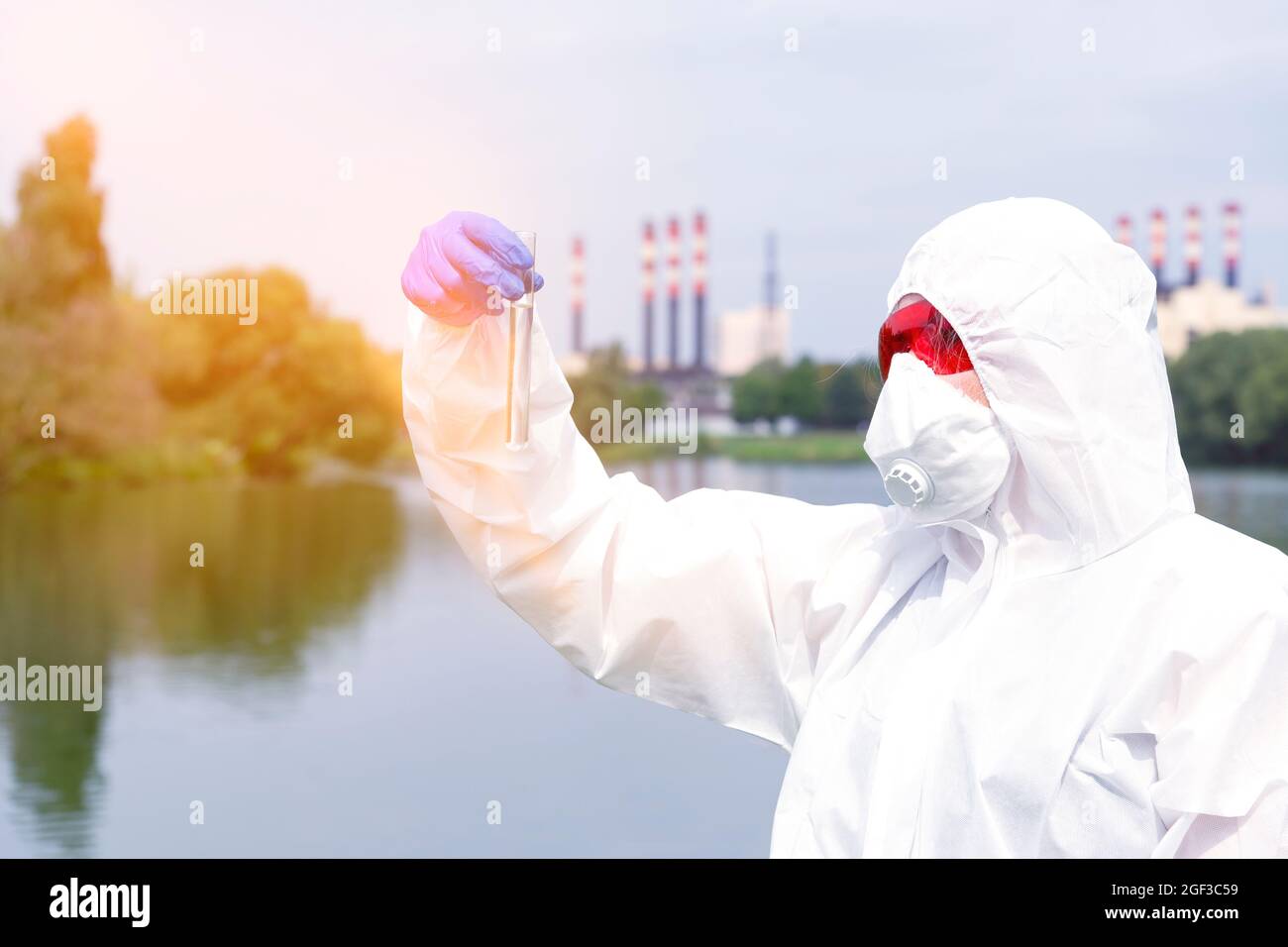 Sampling from open water. A scientist or biologist takes a water sample ...