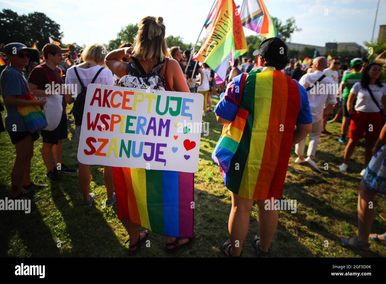 Members of Polish LGBTQ community are seen with rainbow flags and a ...