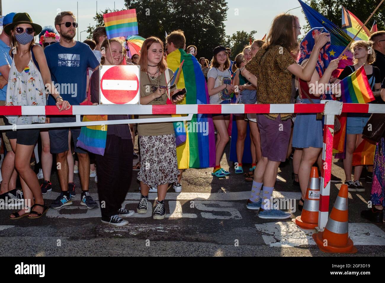 Members of Polish LGBTQ community are seen standing behind a barrier ...