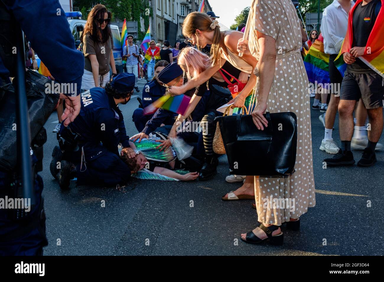 A policeman and participants are seen providing first aid to a woman ...