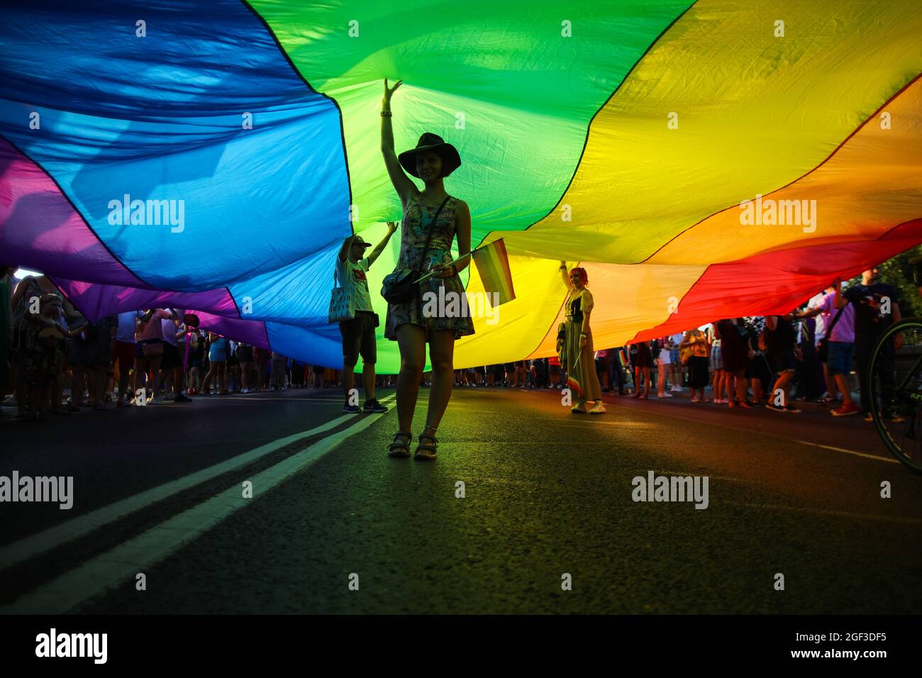 Members of Polish LGBTQ community are seen walking under a giant ...