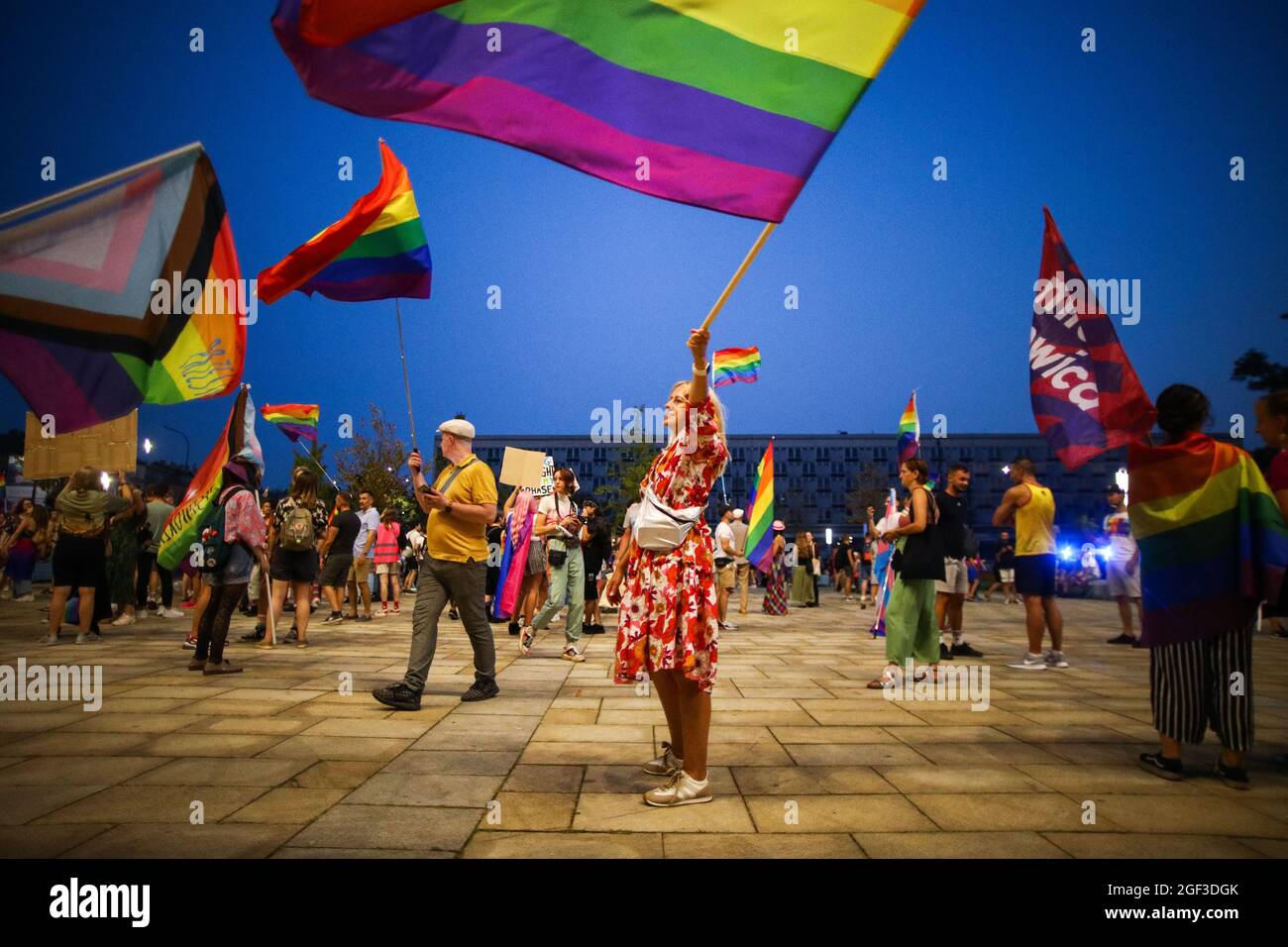 A woman is seen waving a rainbow LGBT pride flag during the march ...