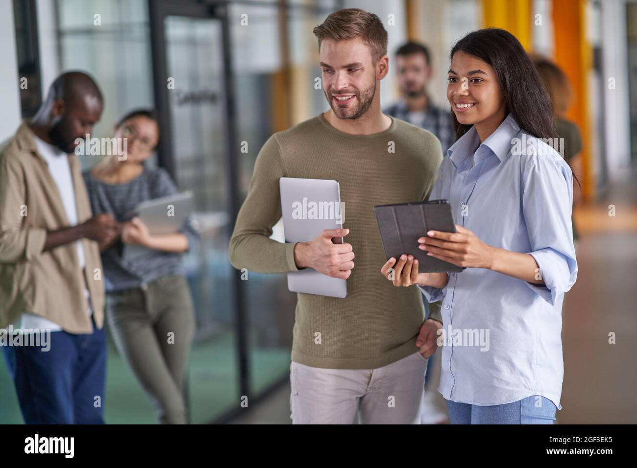 Woman and man holding electronic gadgets and waiting Stock Photo - Alamy