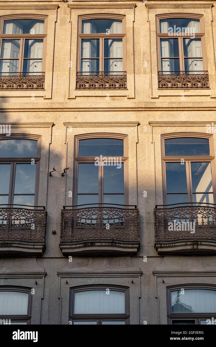 Stone building wall with windows and reflections in them Stock Photo ...
