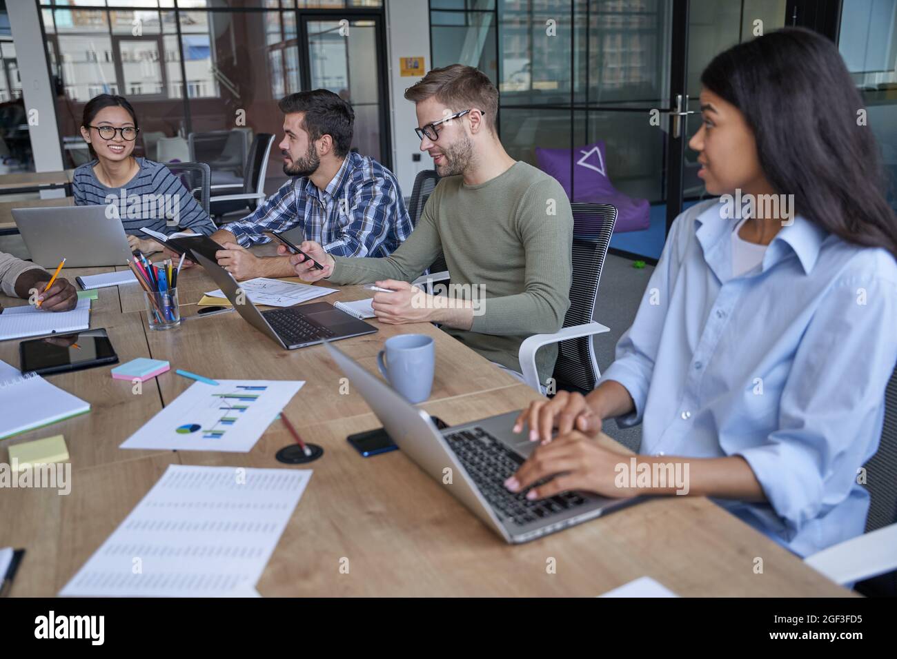 Staff speaking about financial statement together in conference room ...