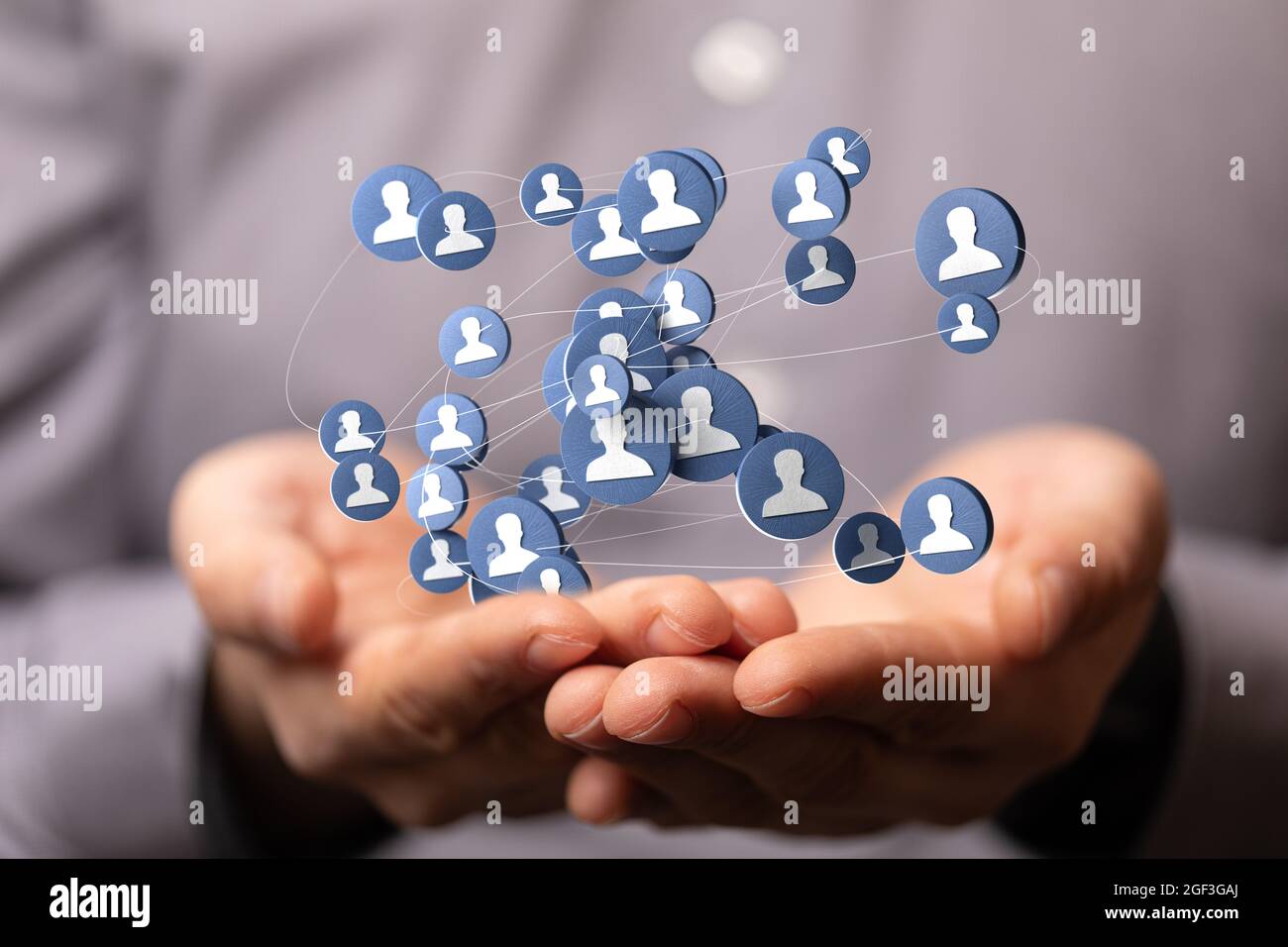 Closeup of people symbols floating above a man's hands Stock Photo - Alamy