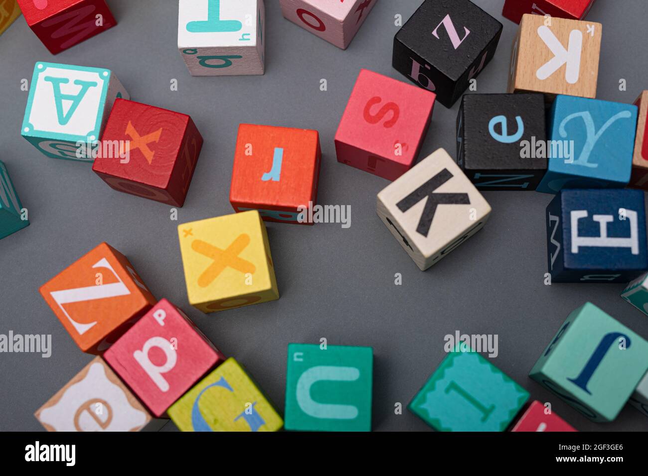 Top view of wooden letter blocks on a grey surface Stock Photo - Alamy