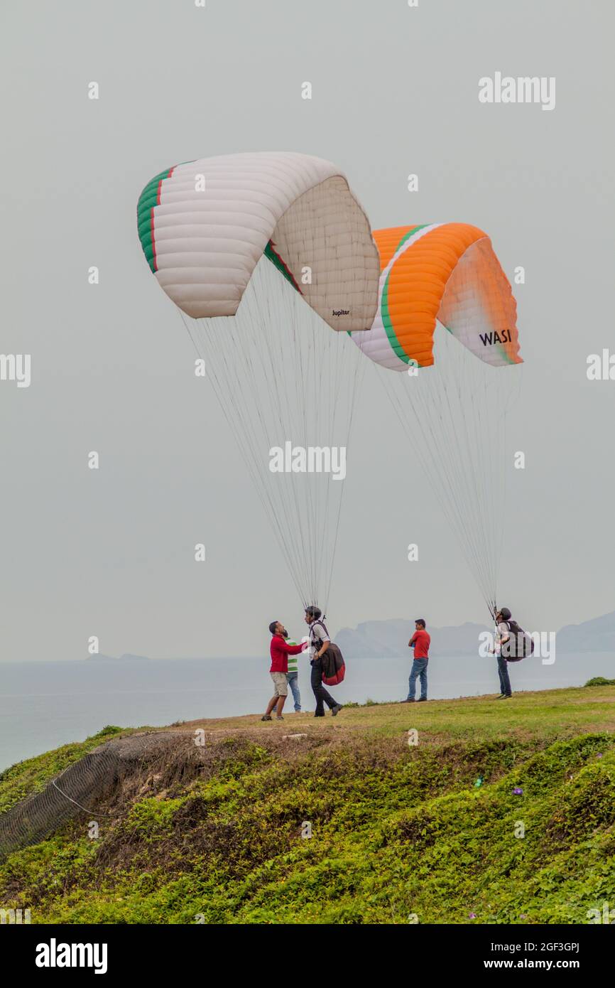 LIMA, PERU - JUNE 4, 2015: Paragliders get ready to fly over cliffs of ...