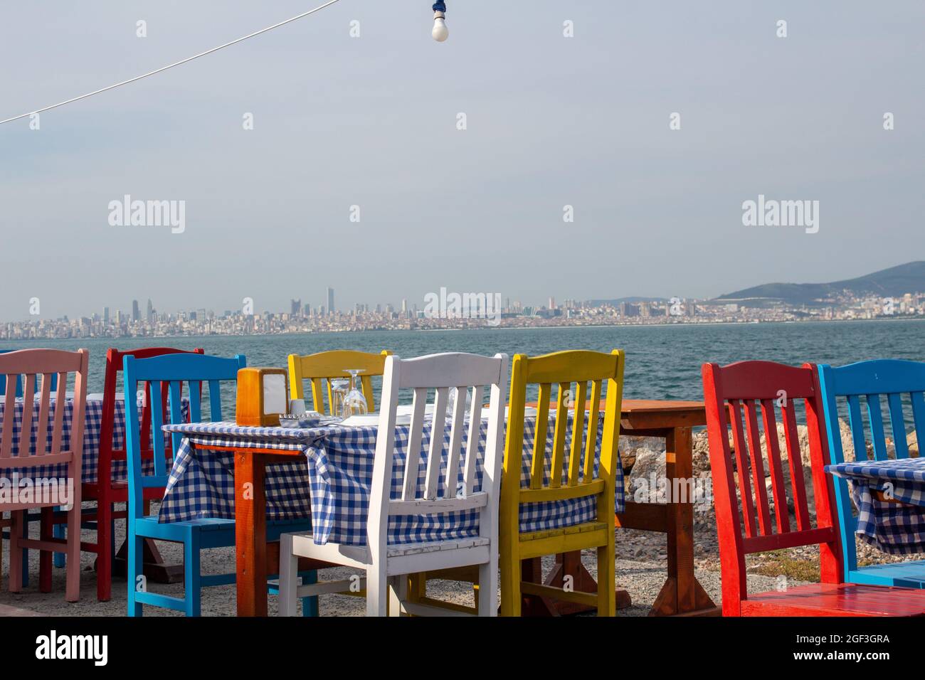Outdoor cafe with colorful chairs and tables on the seaside Stock Photo ...