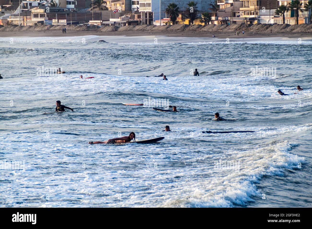 HUANCHACO, PERU - JUNE 6, 2015: People surf in waves of an ocean in ...