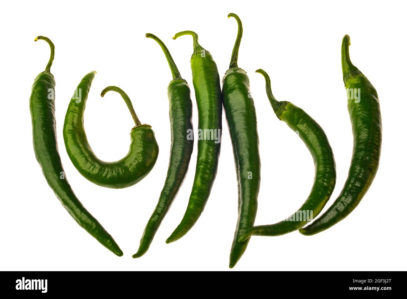 seven green chili pepper isolated on white background Stock Photo - Alamy