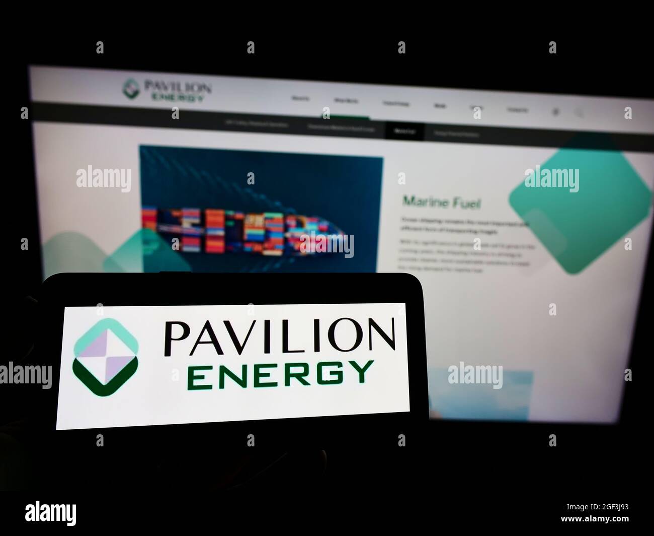 Person holding mobile phone with logo of Singaporean company Pavilion ...