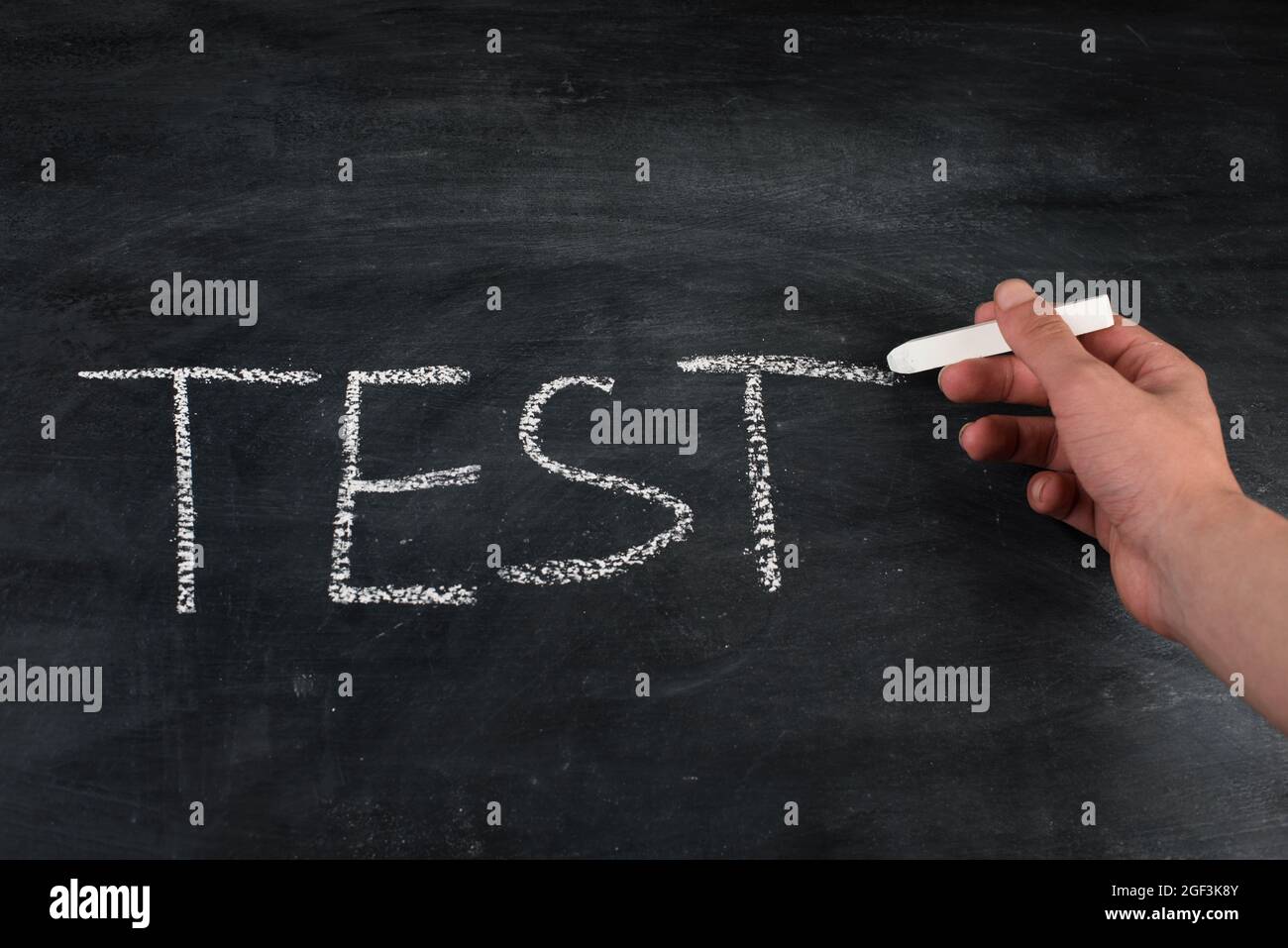 The word test was written on a blackboard with white chalk Stock Photo ...