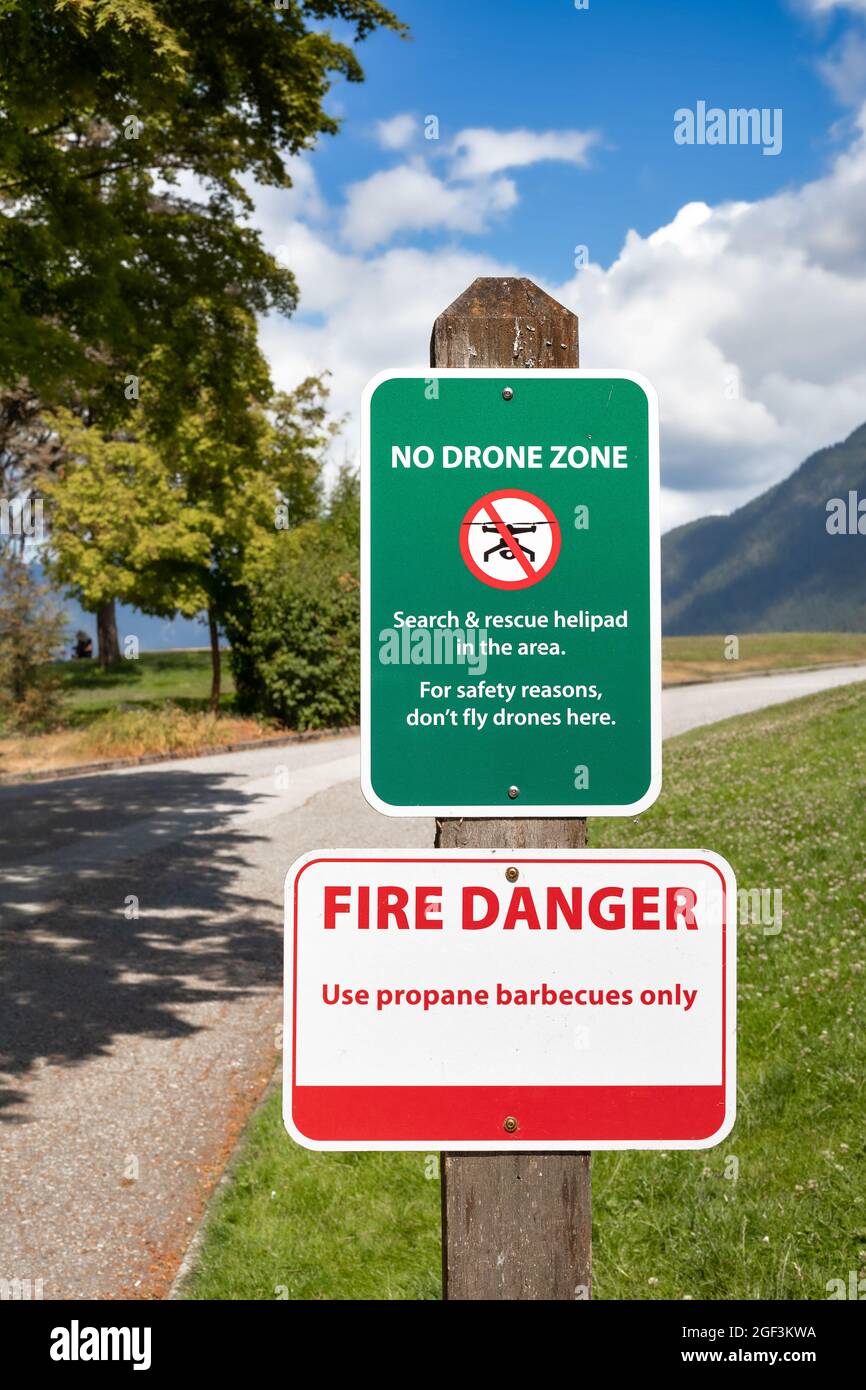 No drone zone signage and fire danger sign in public park. Flying ...