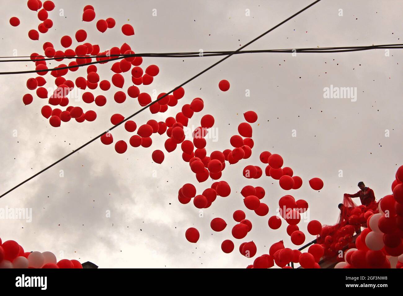 Low angle shot of many red balloons getting released to the air Stock ...
