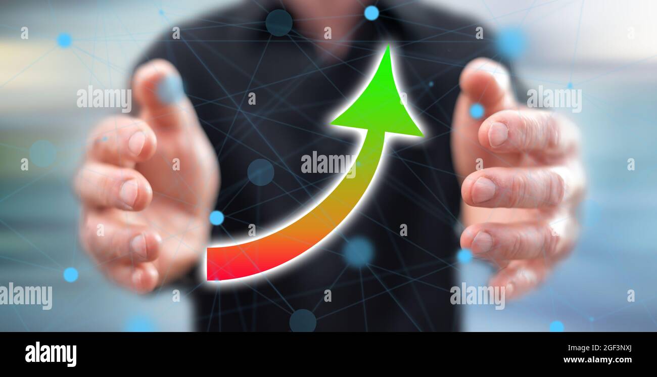 Growth concept between hands of a man in background Stock Photo - Alamy