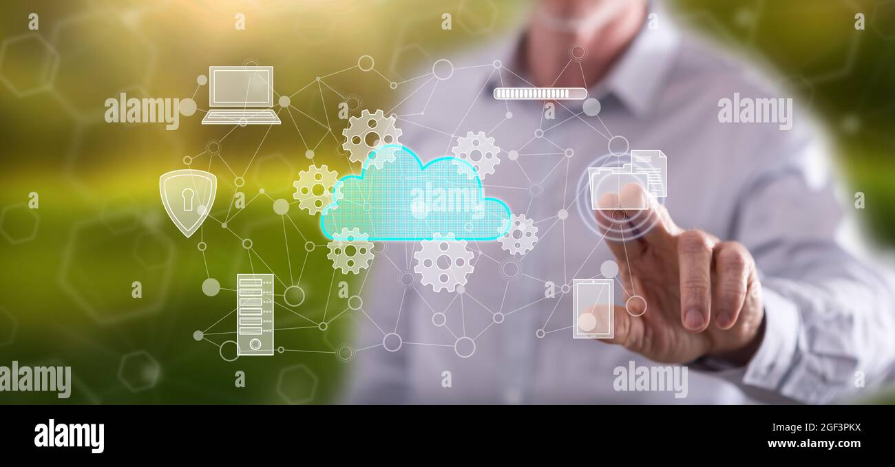 Man touching a cloud computing concept on a touch screen with his ...