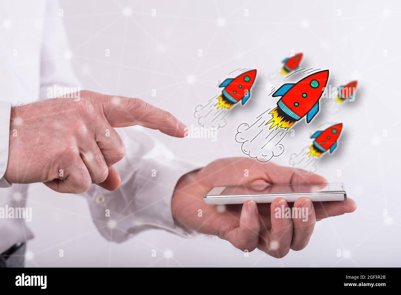Start up concept above a smartphone held by a man Stock Photo - Alamy