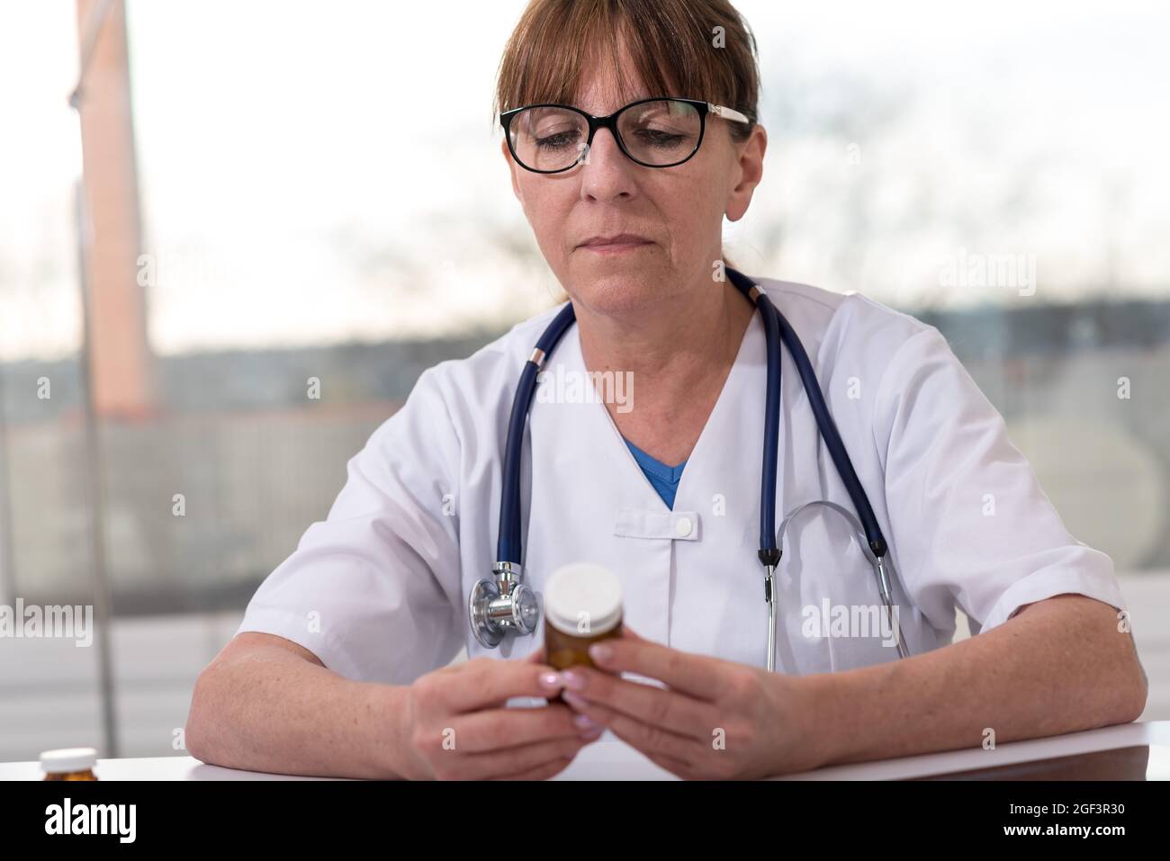 Portrait of mature female doctor checking medicine Stock Photo - Alamy