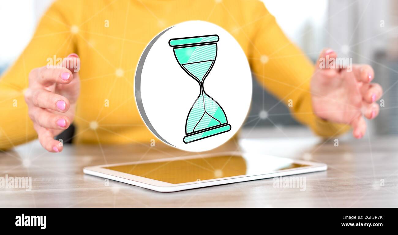 Digital tablet with time management concept between hands of a woman in ...