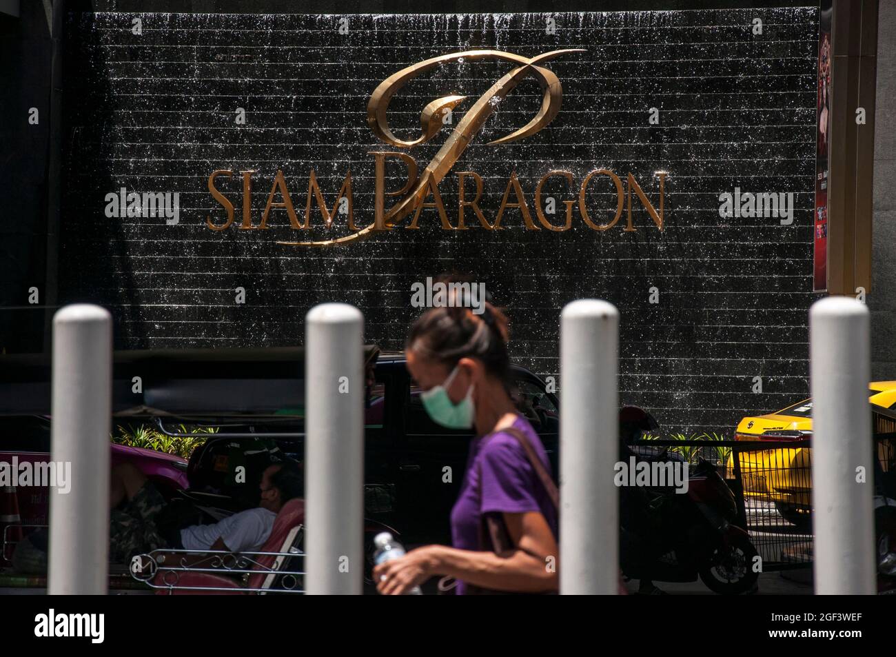 A woman wearing a face mask as a precaution against the spread of covid ...
