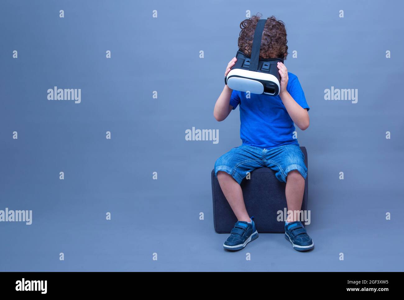 child sitting and playing with virtual reality goggles Stock Photo - Alamy
