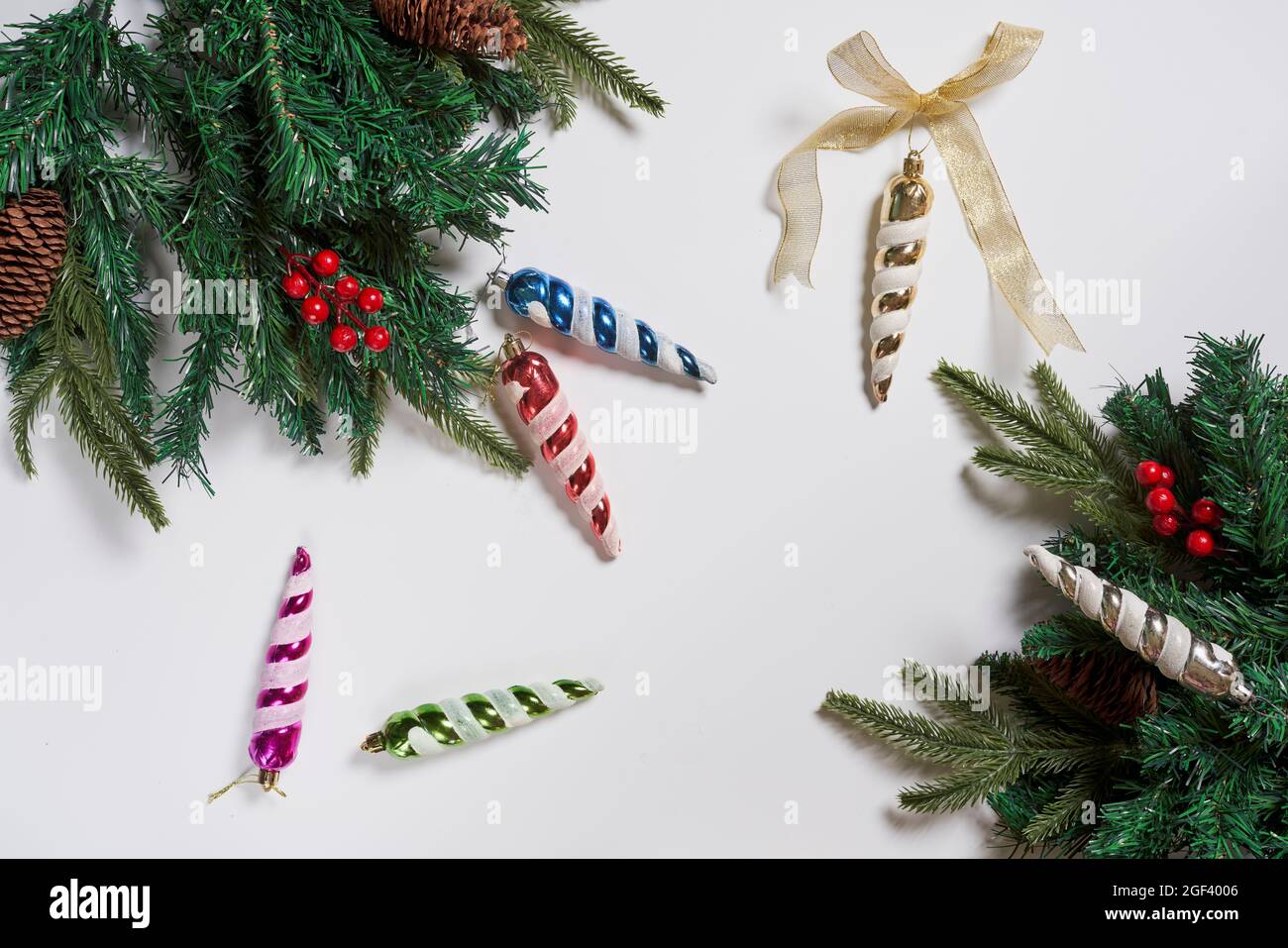 Branches of spruce tree with pine cones and Christmas toy decorations ...