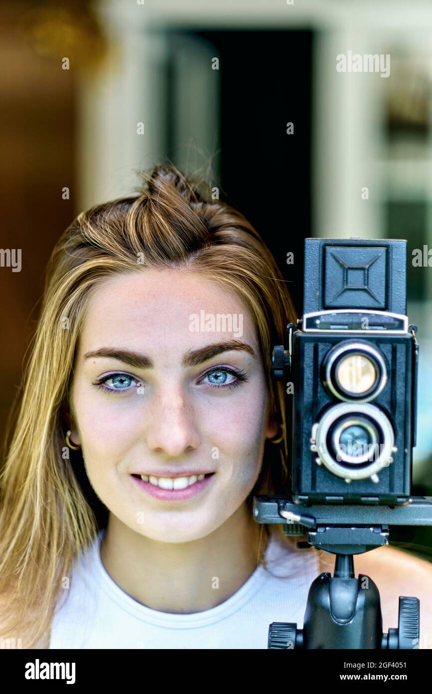 Portrait of a young beautiful caucasian woman in her 20´s with blue ...