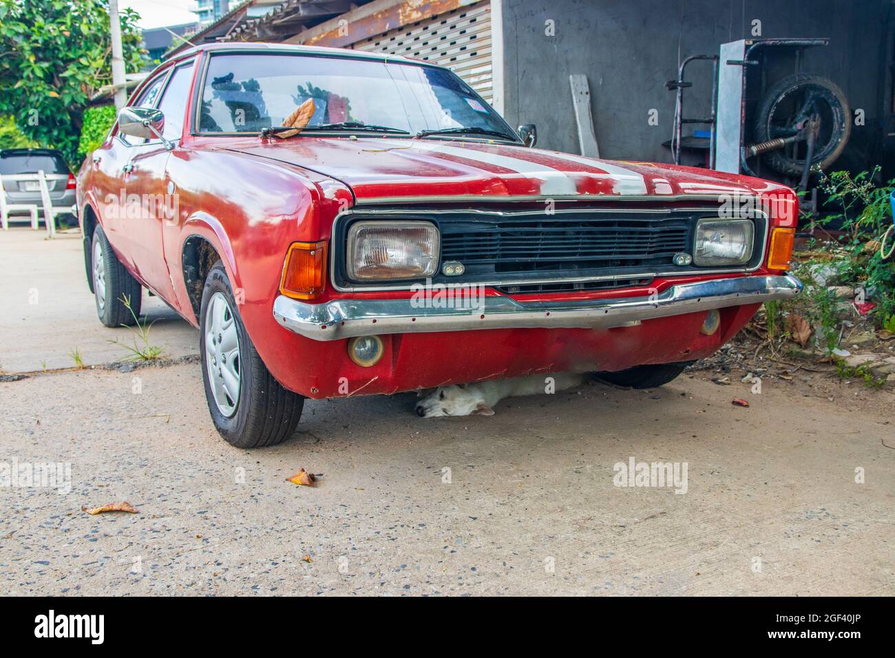 an old red Ford car on the side of the road Stock Photo - Alamy