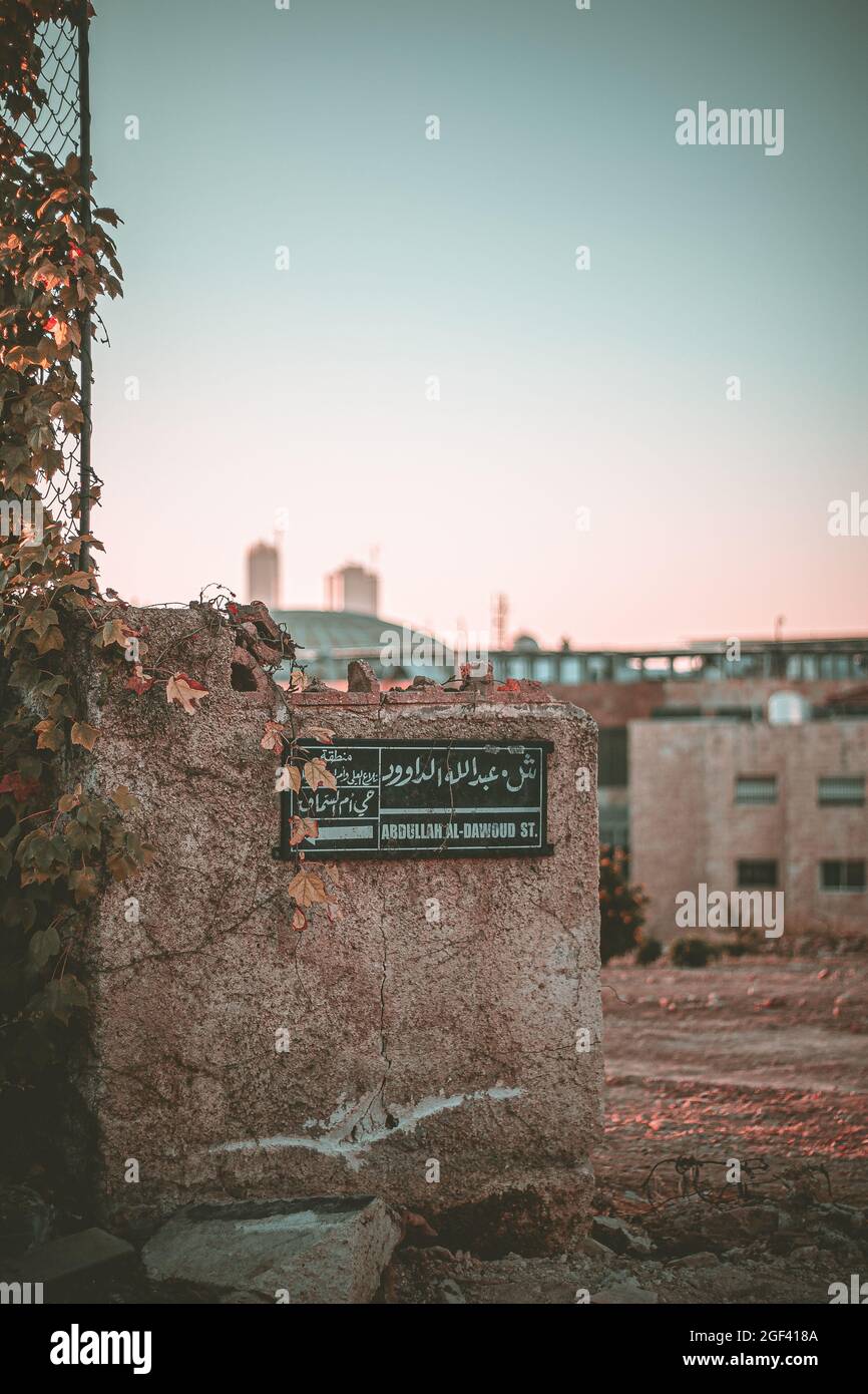 Vertical shot of street signs on ruined building walls under the ...
