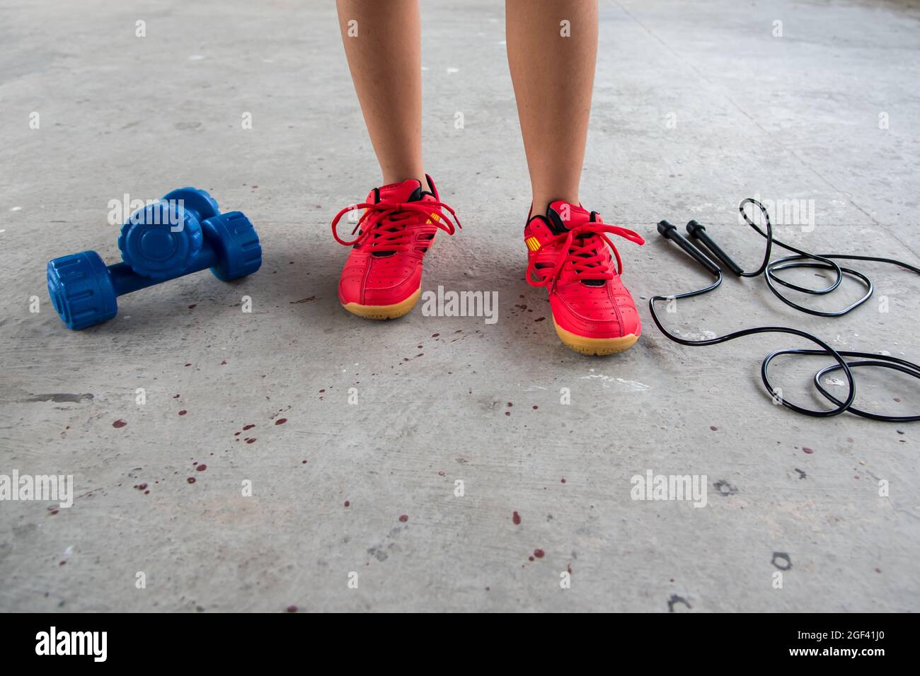 Sports and recreation background with legs of a boy, dumb bells and ...