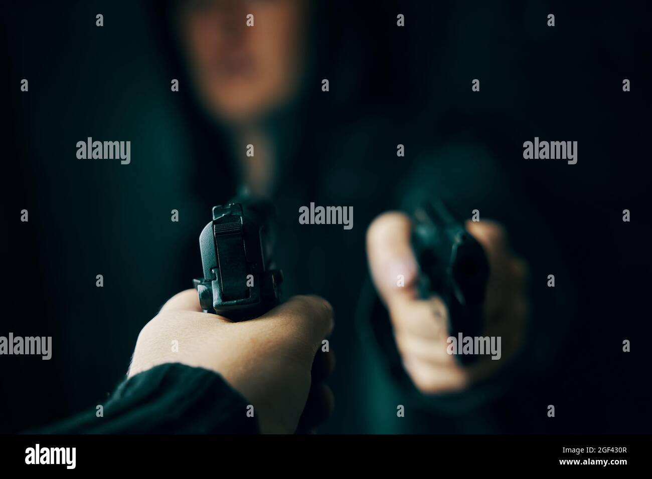 First-person view of hand with pistol pointed at guy in hoody with ...
