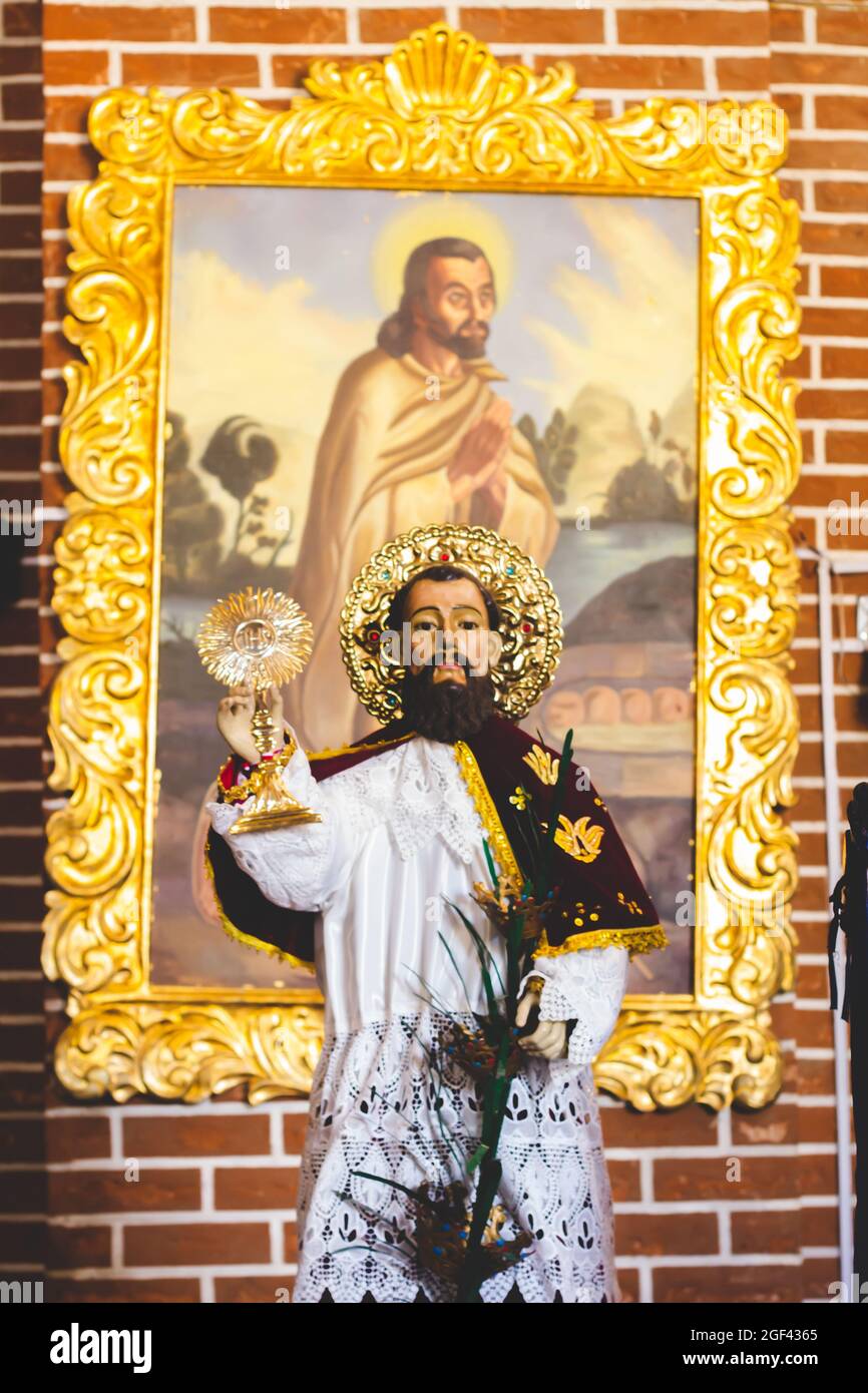 Vertical closeup of the icon of Jesus Christ with a small statue ...