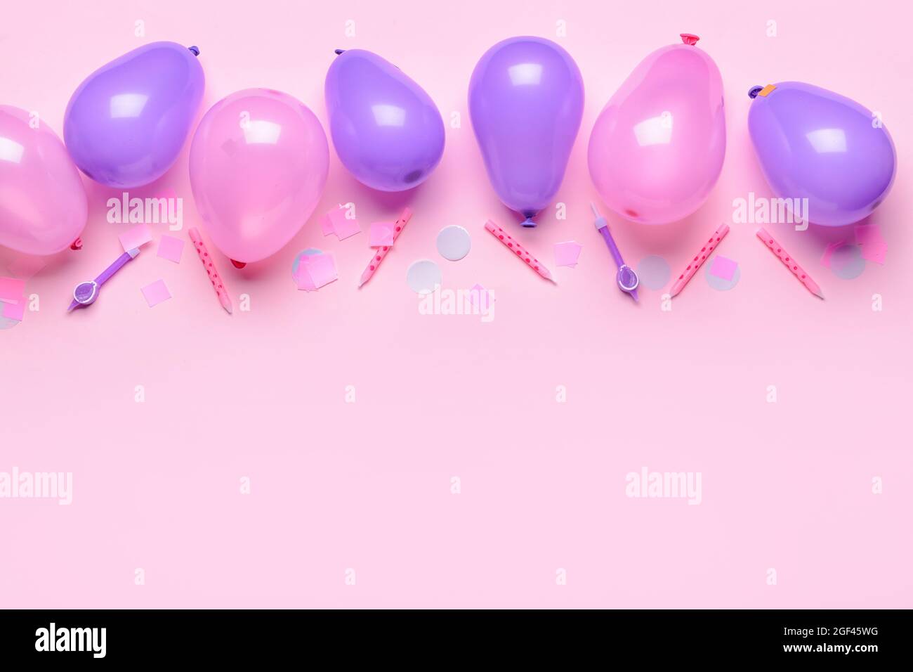 Balloons, candles and confetti on color background Stock Photo - Alamy