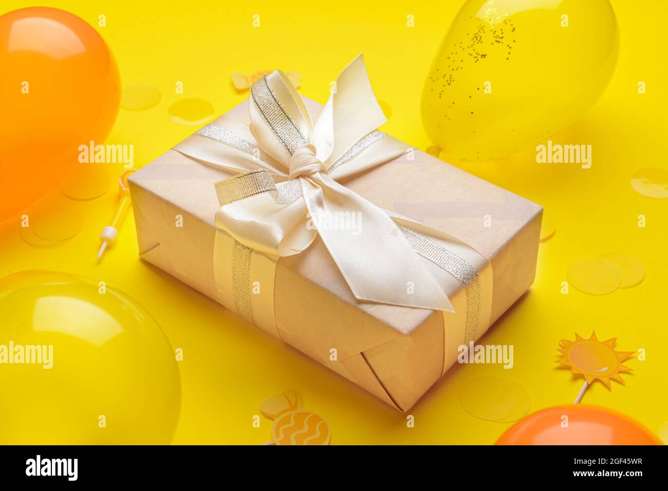 Gift box, balloons and confetti on color background, closeup Stock ...