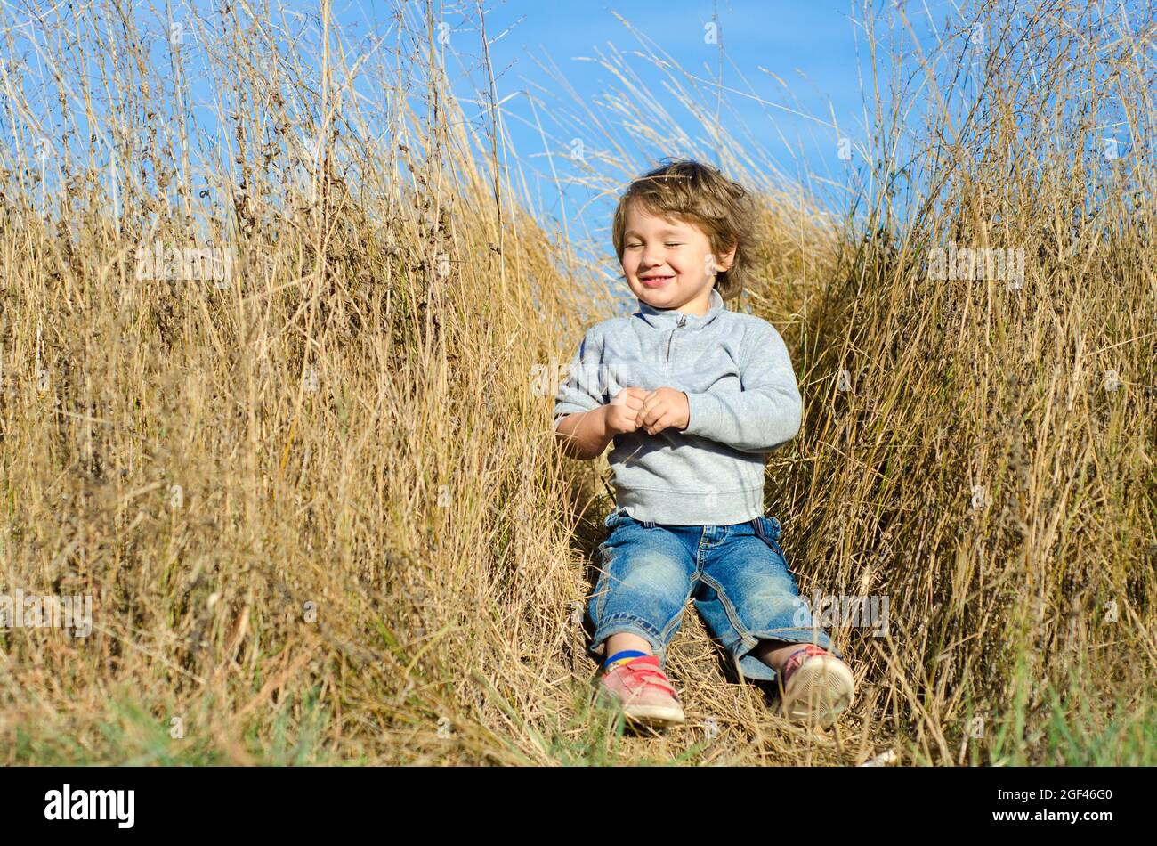 smiling little boy on a rural field Stock Photo - Alamy