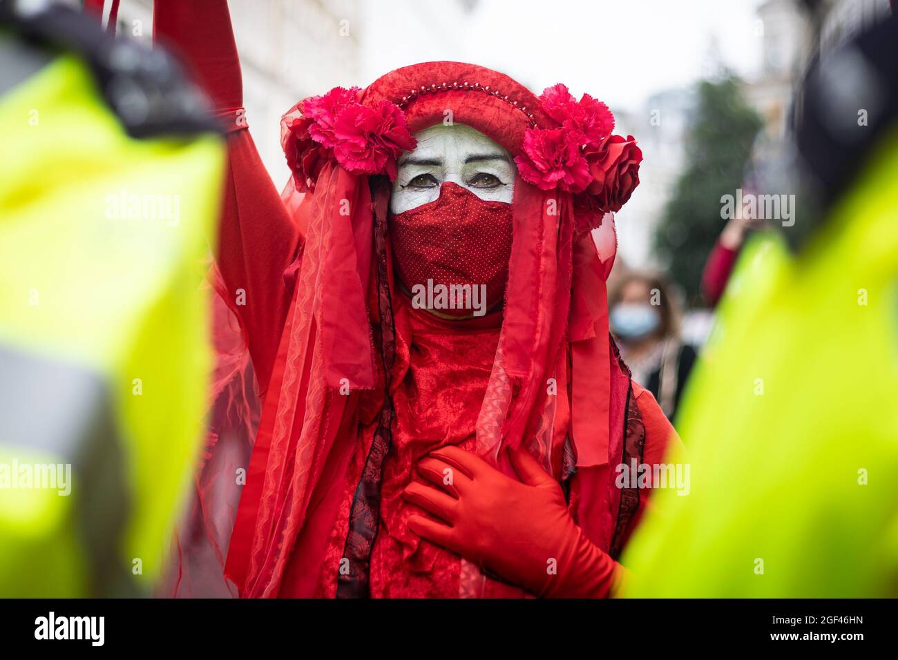 London, UK. 23rd Aug, 2021. Extinction Rebellion Red Rebel Brigade ...