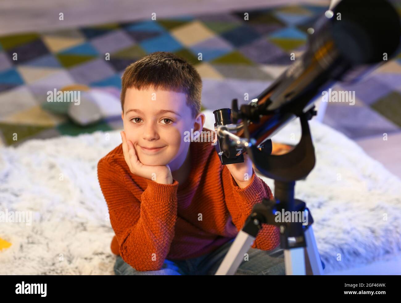 Little boy with telescope looking at stars in evening Stock Photo - Alamy