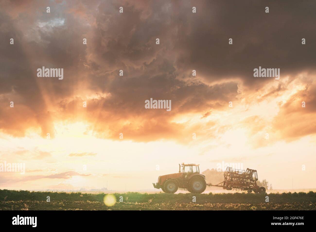 Tractor On Road In Spring Season. Beginning Of Agricultural Spring ...