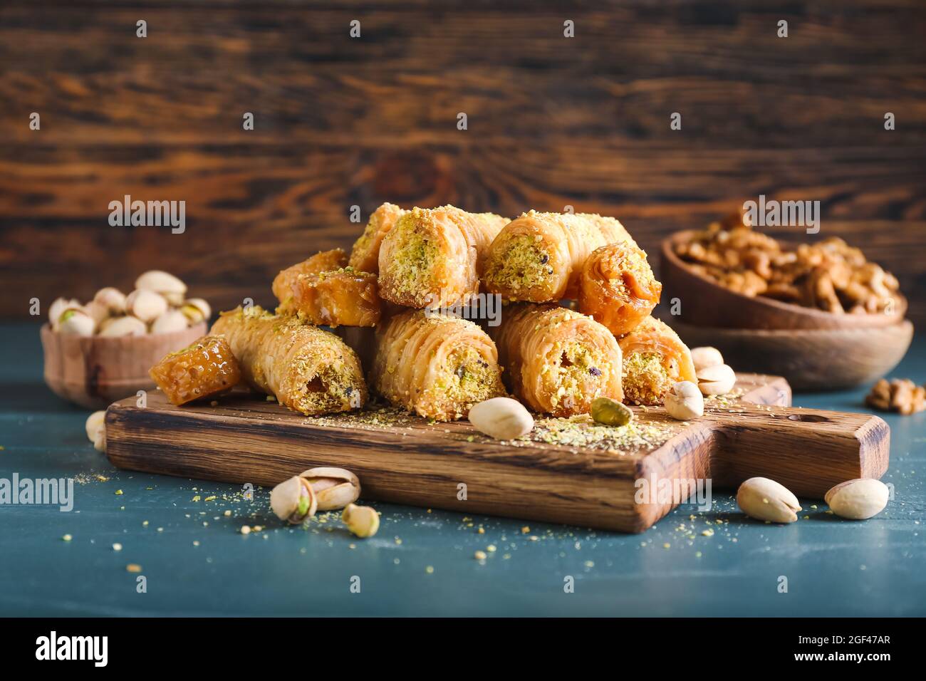 Board with delicious baklava on color wooden background Stock Photo - Alamy