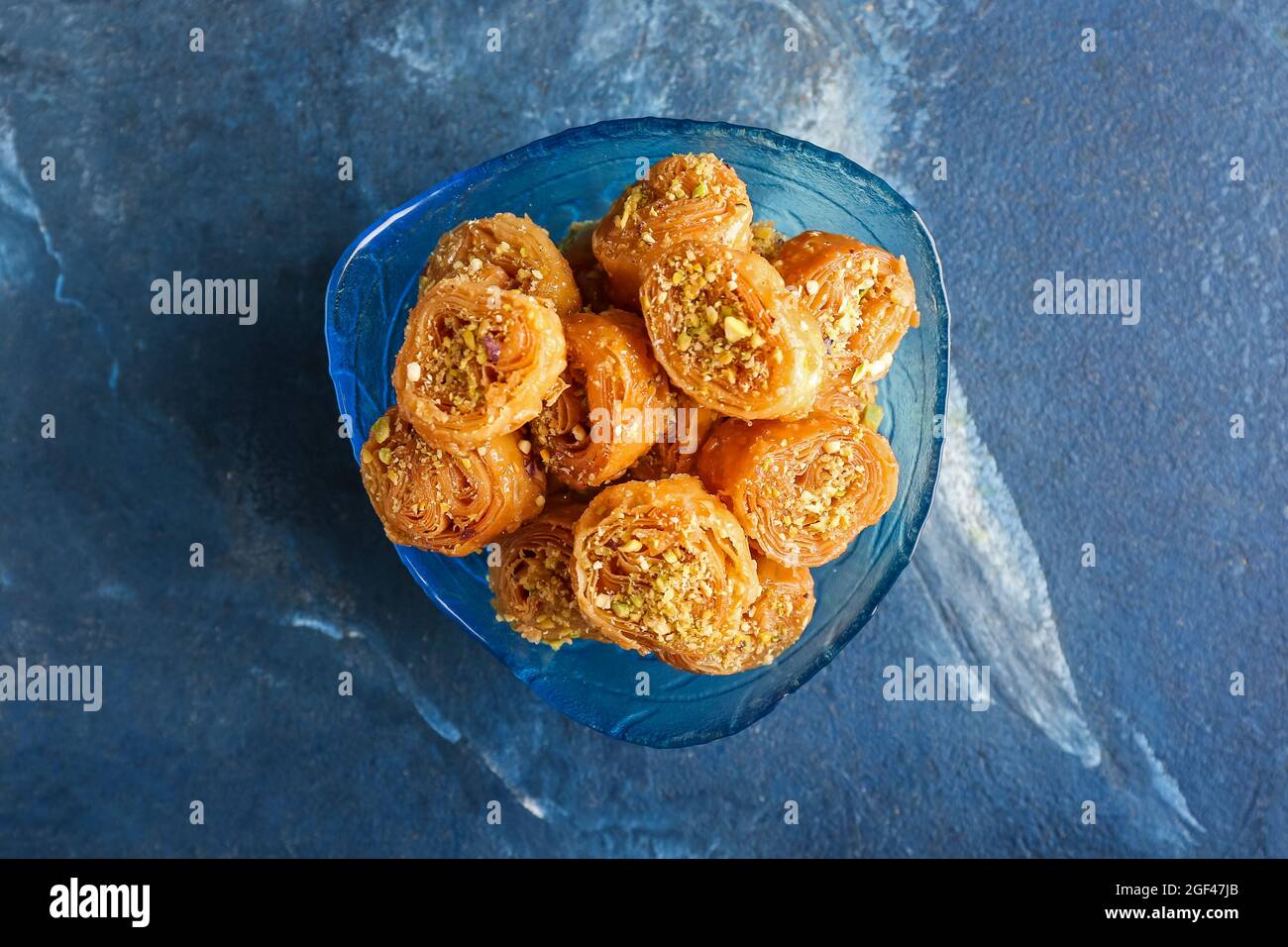 Bowl with delicious baklava on color background Stock Photo - Alamy