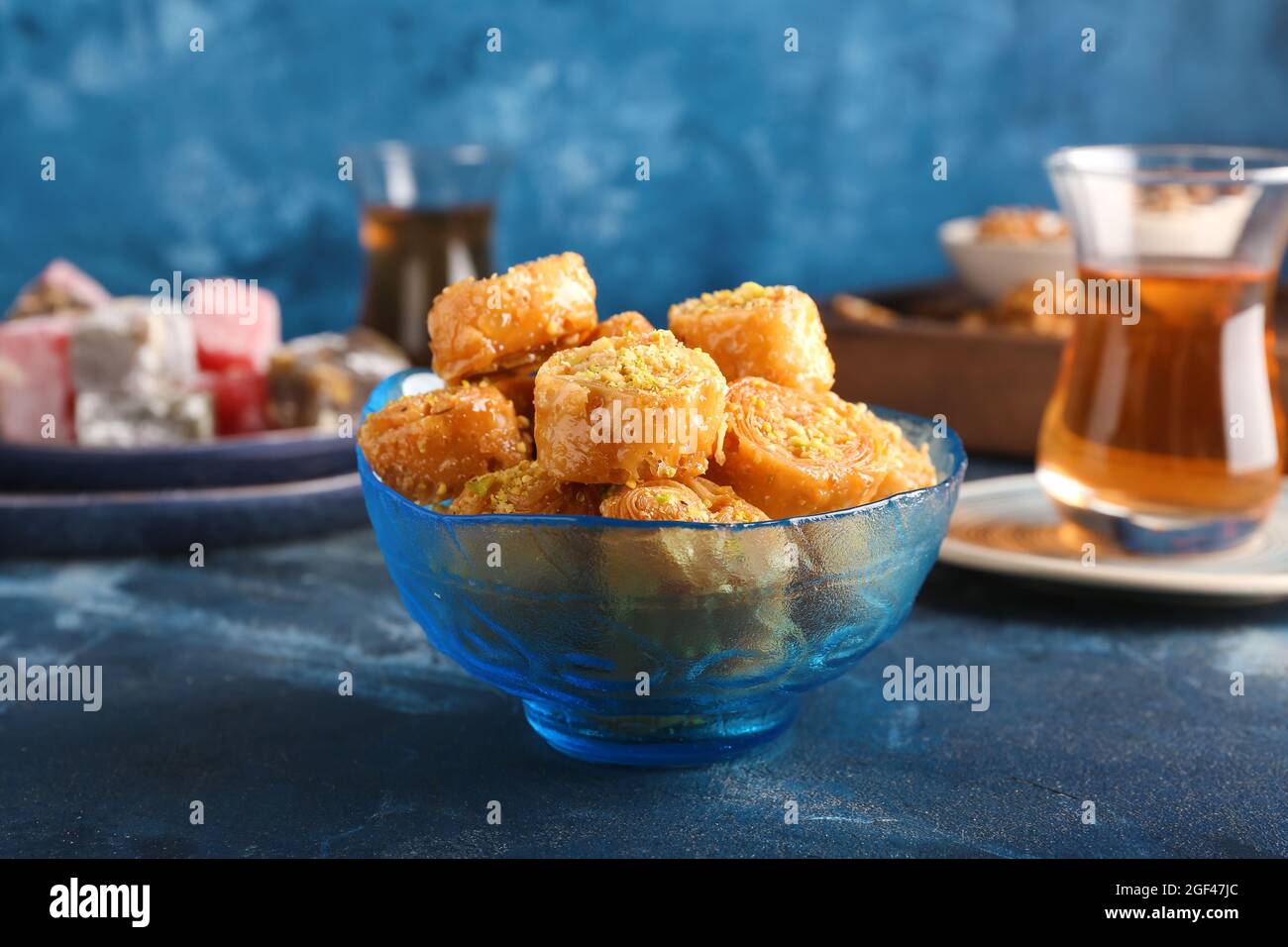 Bowl with delicious baklava on color background Stock Photo - Alamy