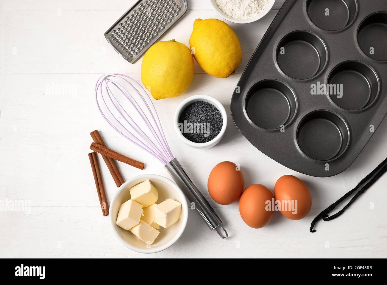 Baking tin and ingredients for delicious muffins with poppy seeds on ...