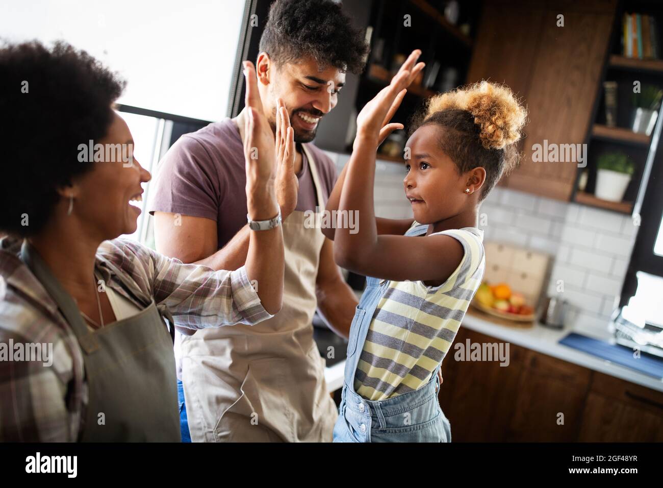 Happy family having fun together at home in the kitchen Stock Photo - Alamy