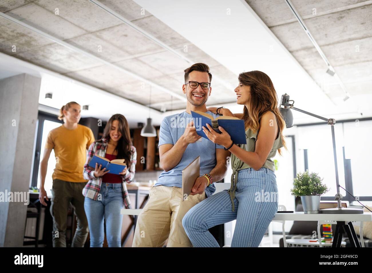 Group of happy young students having fun while studying together for ...